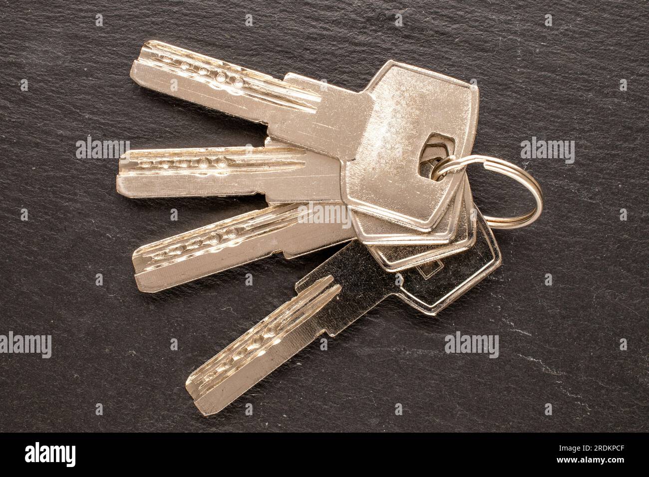 Several keys to a door lock on a slate stone, close-up, top view Stock ...