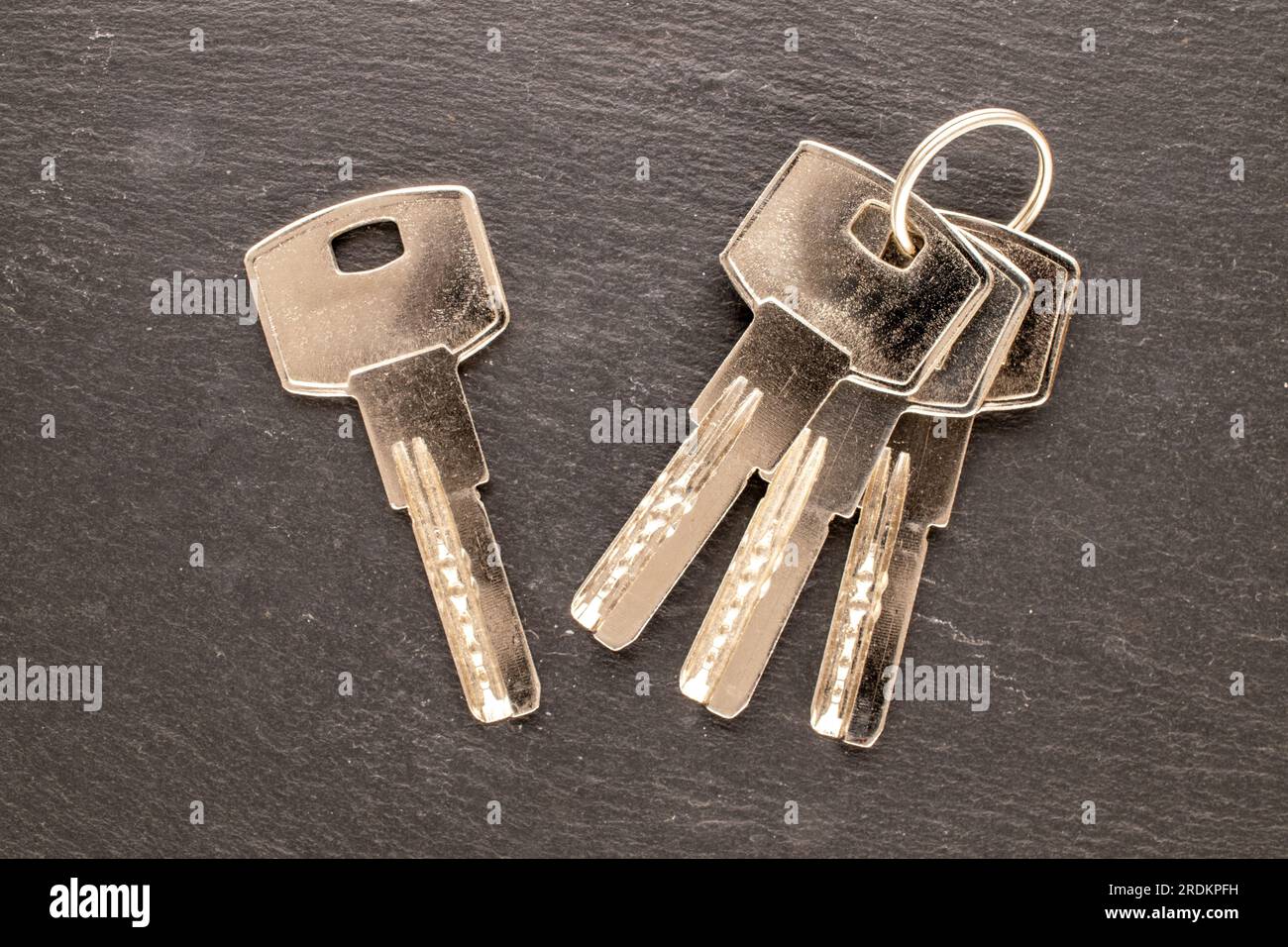 Several keys to a door lock on a slate stone, close-up, top view Stock ...