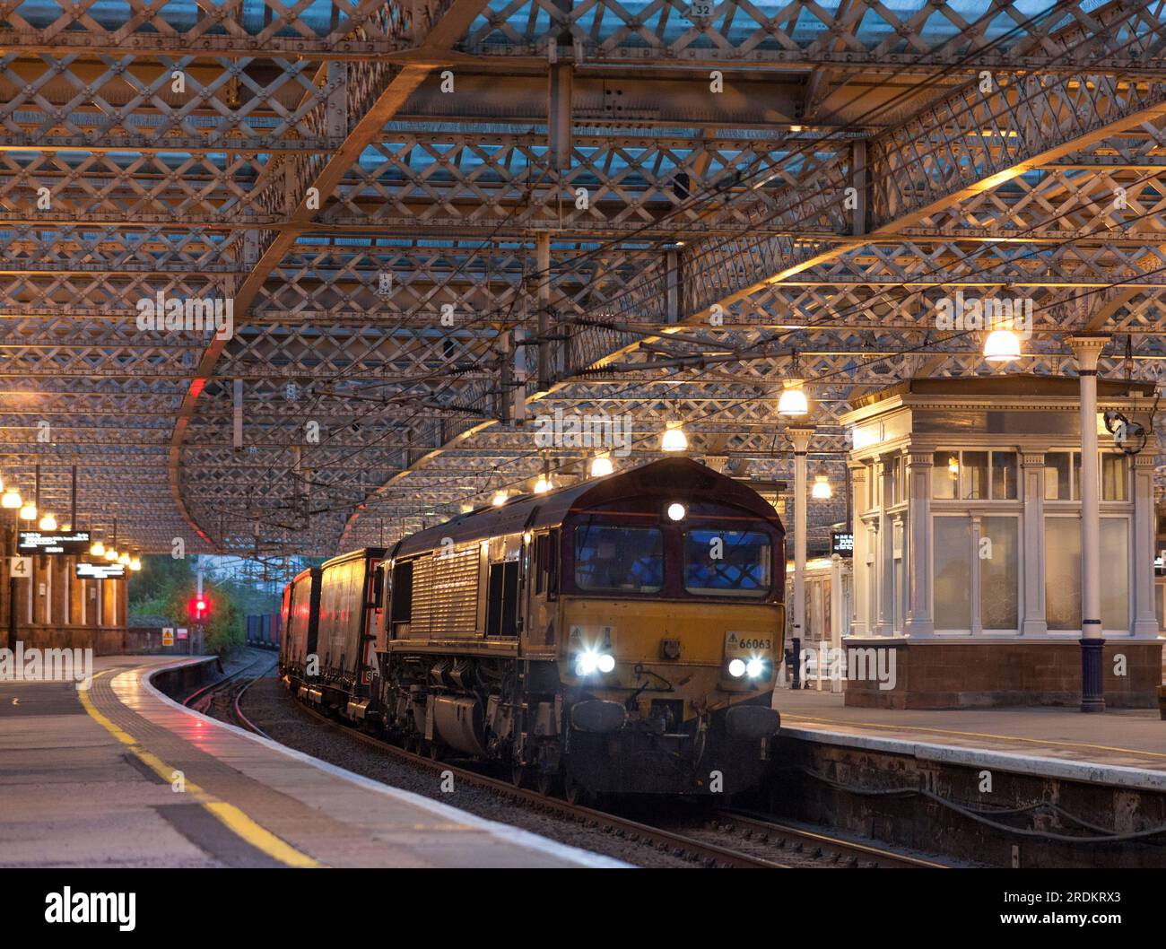 DB Cargo rail class 66 diesel locomotive 66063 passing the station at ...