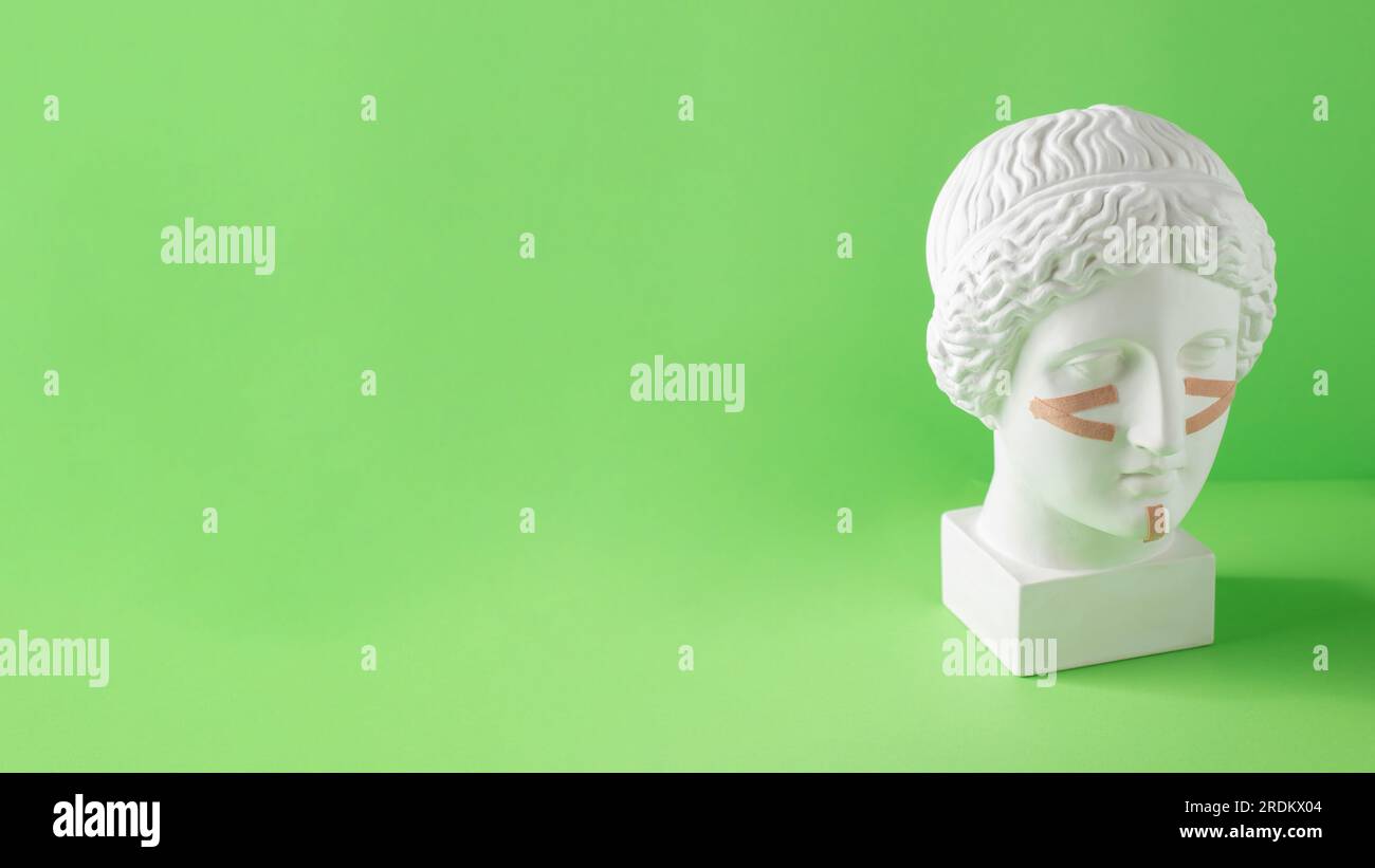 Beige tapes for the face on the bust on a green background. Non ...