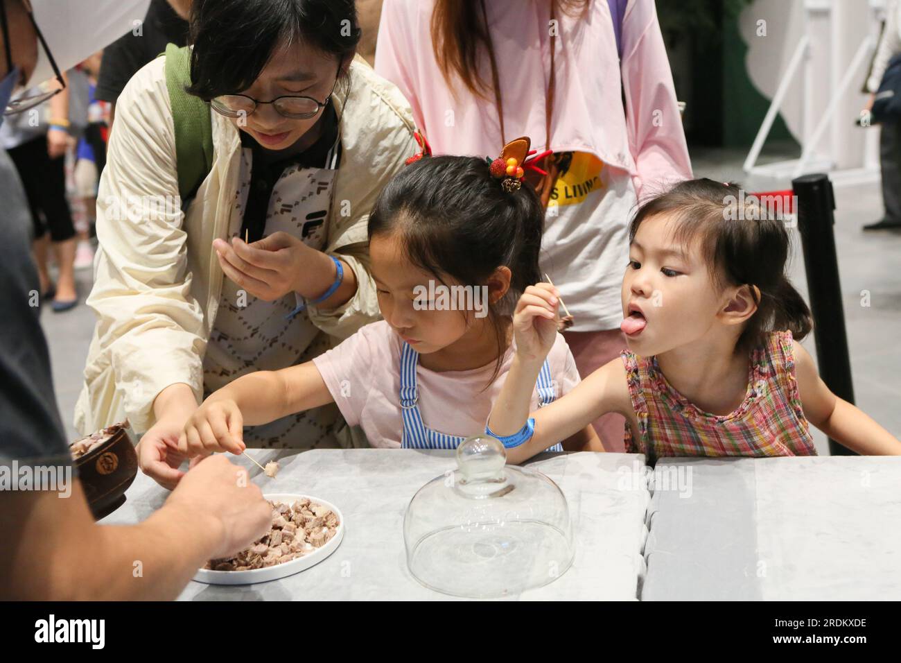 Shanghai. 21st July, 2023. Visitors taste Mongolian specialty food at a ...