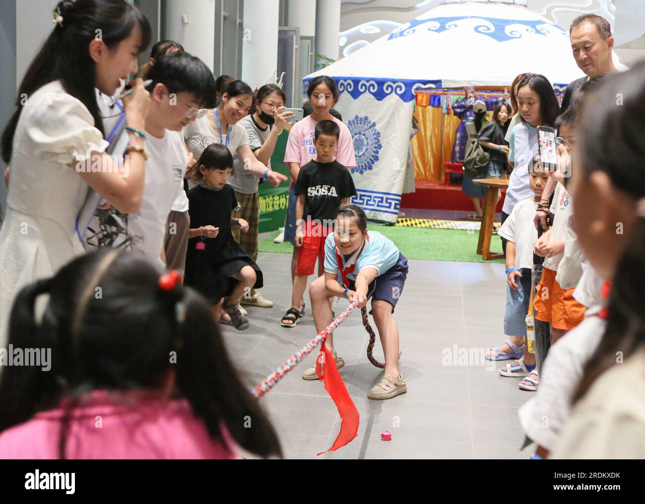 Shanghai. 21st July, 2023. Children take part in a traditional tug-of ...