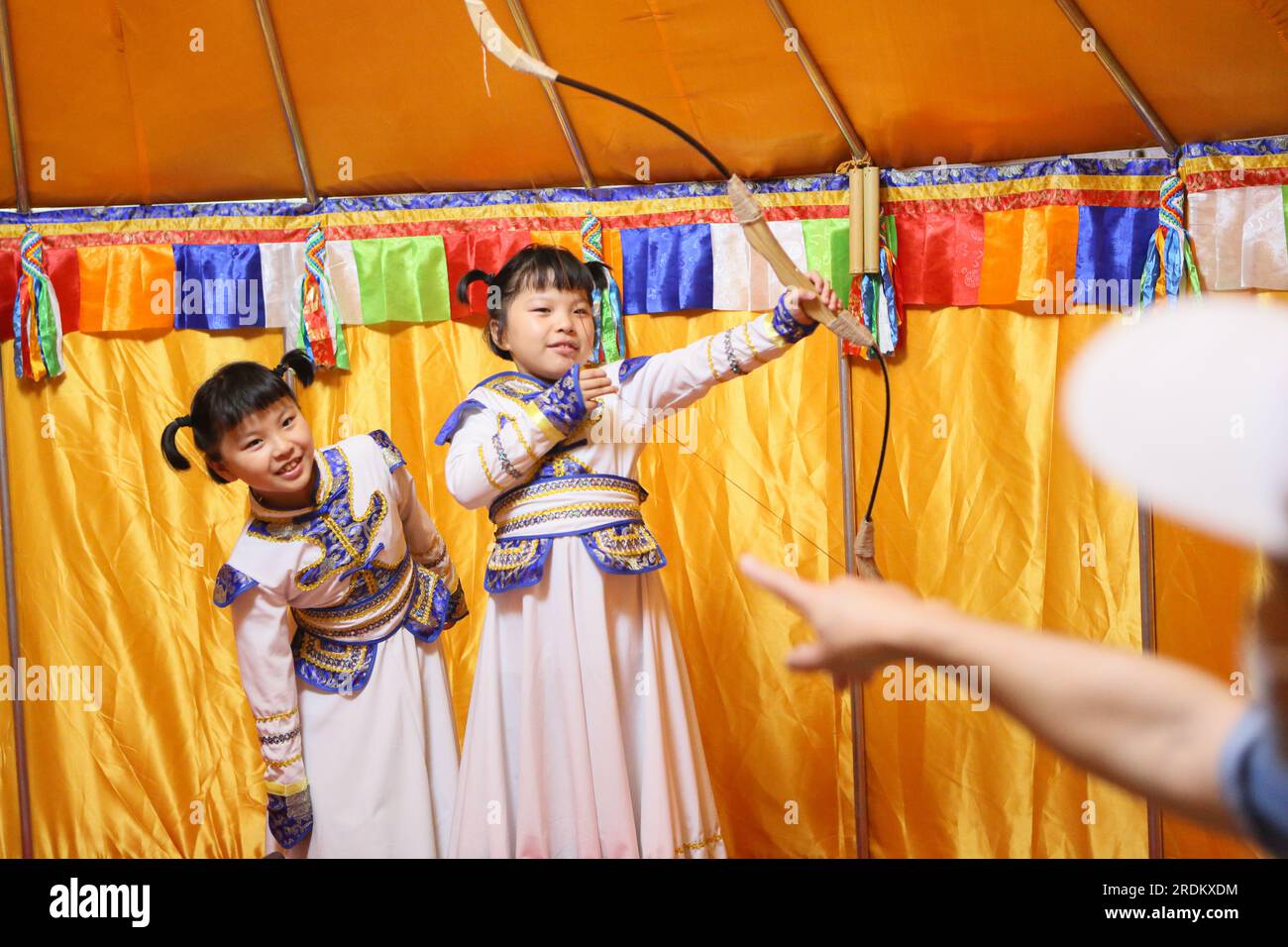 Shanghai. 21st July, 2023. Children try on ethnic costumes and pose for ...