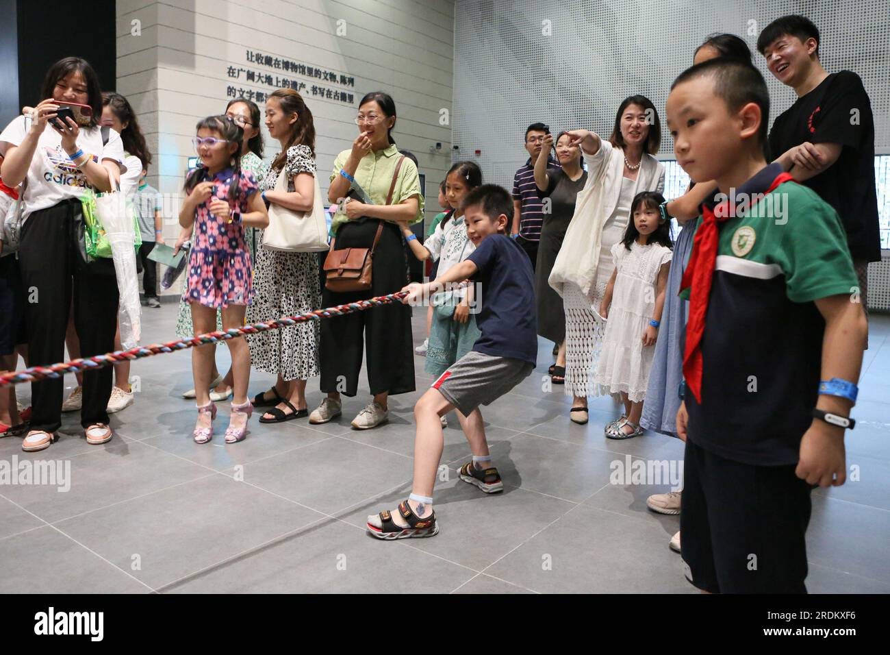 Shanghai. 21st July, 2023. A boy takes part in a traditional tug-of-war ...