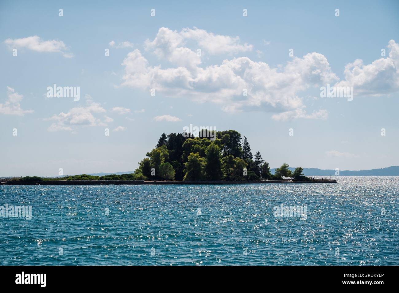 Small island with green trees surrounded by water Stock Photo - Alamy
