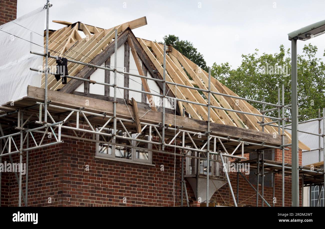 Europe, UK, England, Surrey, scaffolding on house roof renovation Stock ...