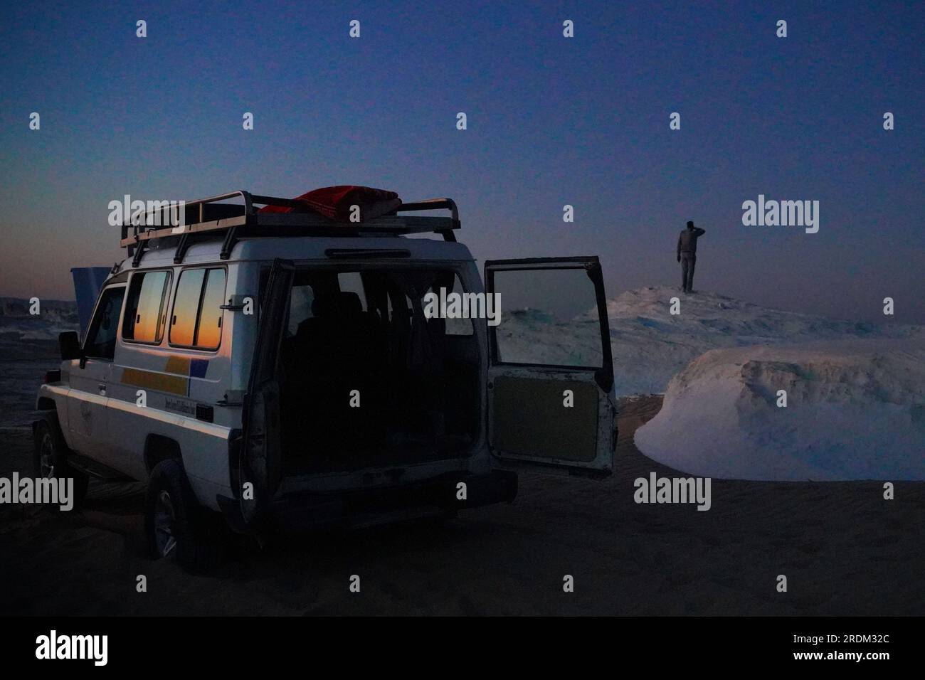 A man seen standing on a calcified rock in the White Desert, Egypt ...