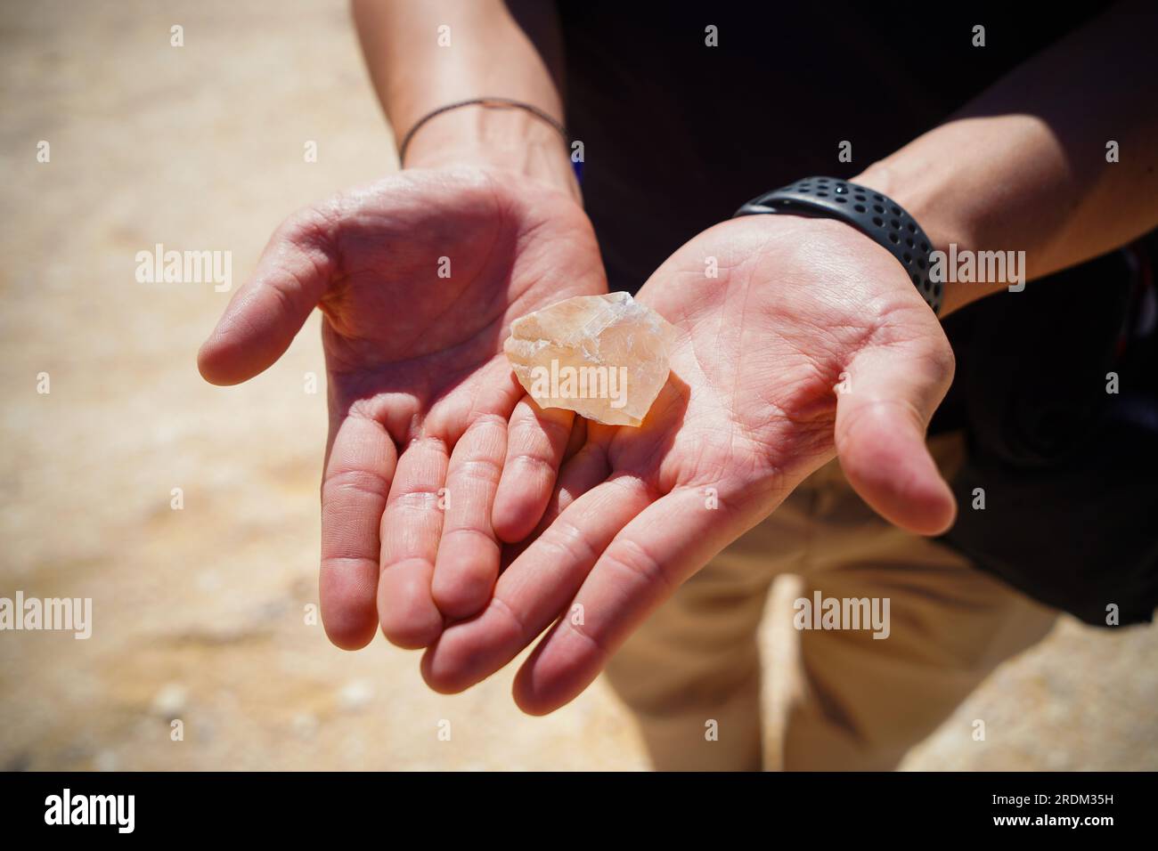 A tourist seen showing a piece of quartz found on the ground near the ...