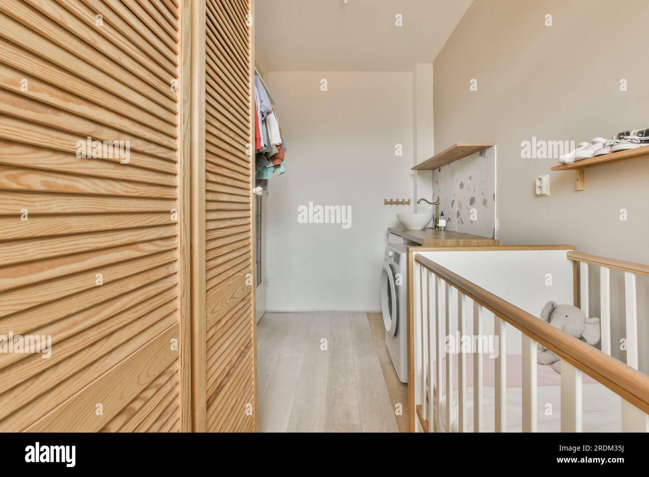 a laundry room with wooden walls and white washer in the wall is made ...