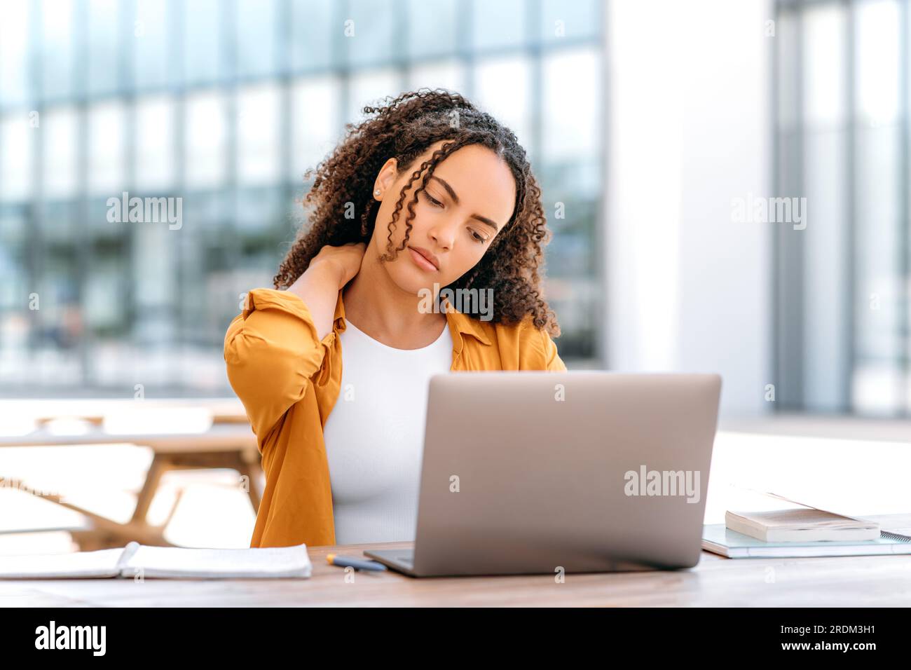 Tired overworked curly brazilian or hispanic girl, in casual wear ...