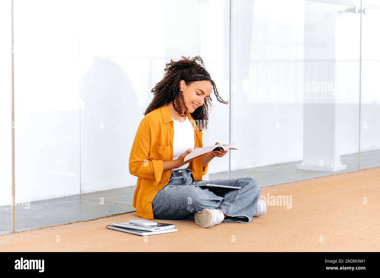 Lovely positive stylish curly haired brazilian or hispanic female ...