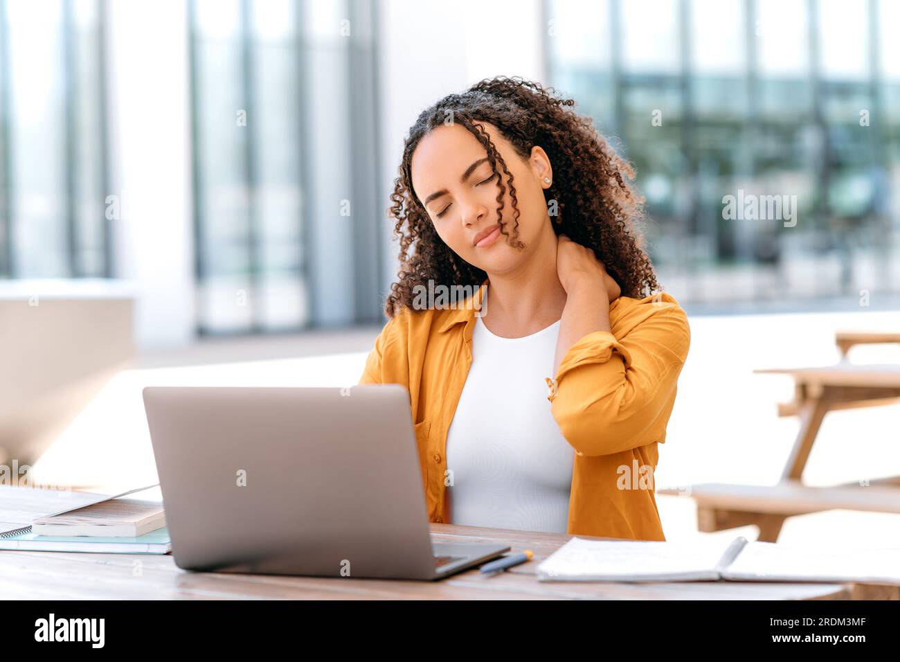 Neck pain. Tired overworked curly haired young hispanic woman, in ...