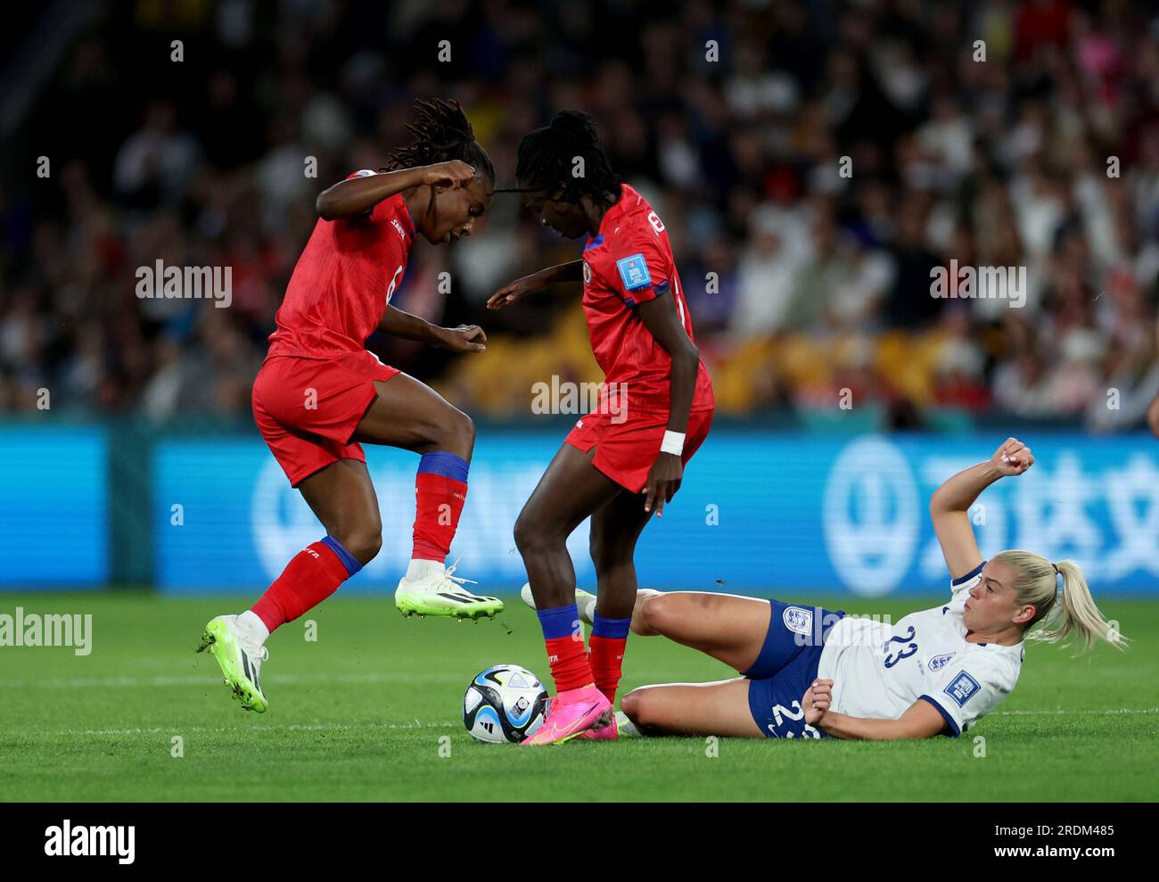 Haiti's Melchie Dumornay (left) and Sherly Jeudy battle for the ball with England's Alessia ...