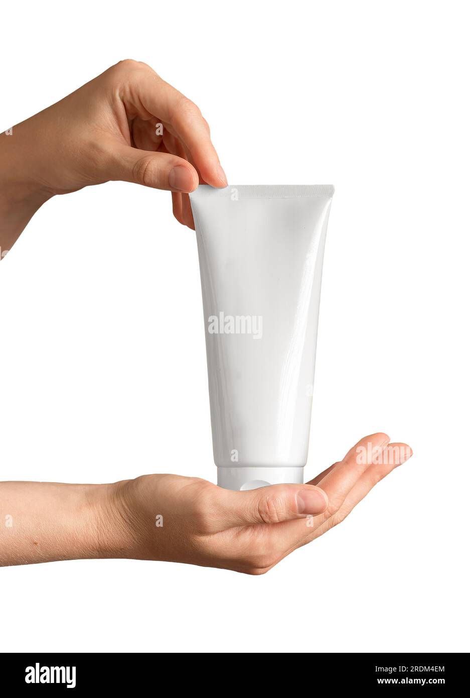 Hand holding small cream tube isolated white background Stock Photo - Alamy