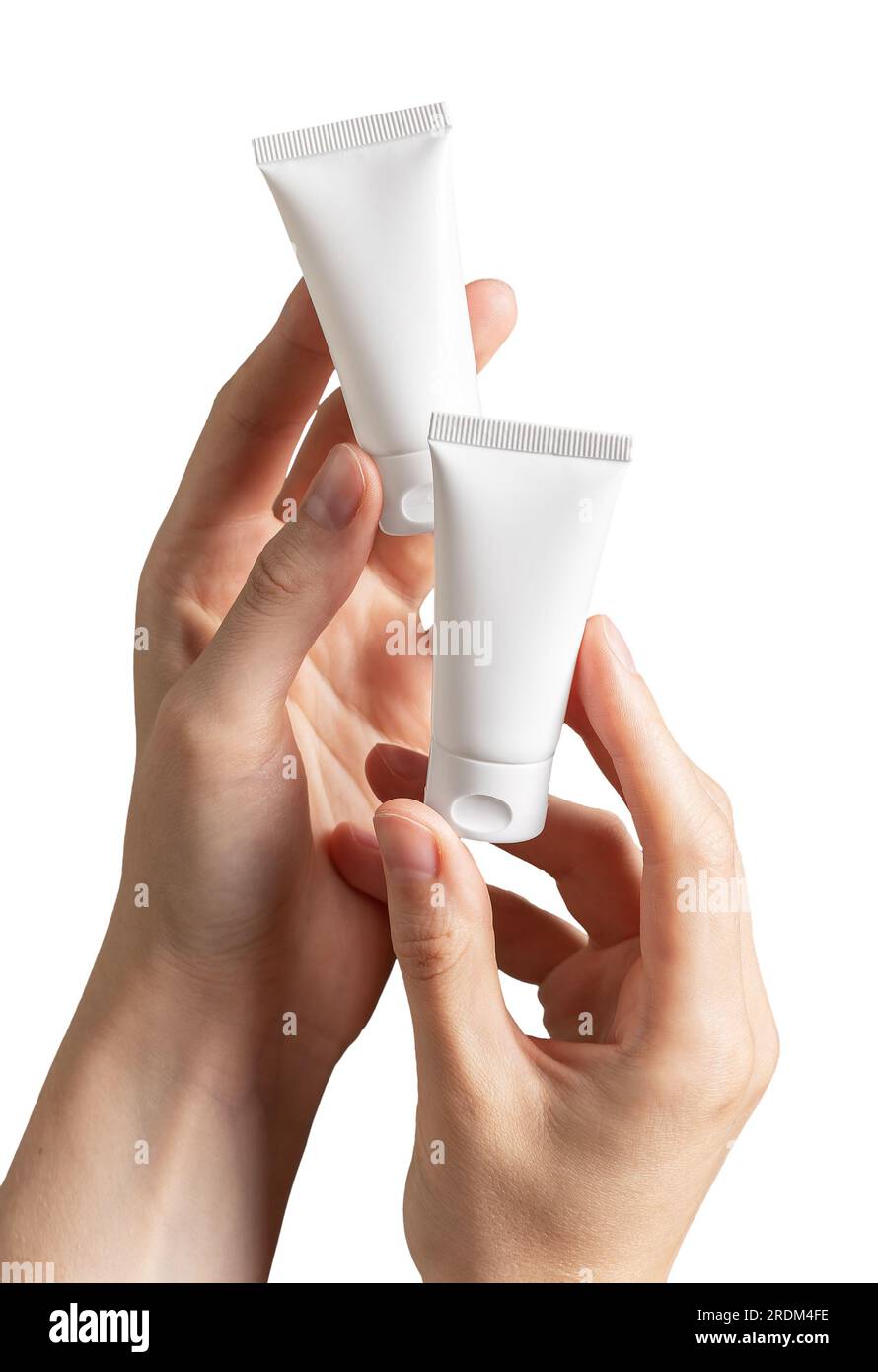 Hand holding two small cream tubes mockups isolated white background ...