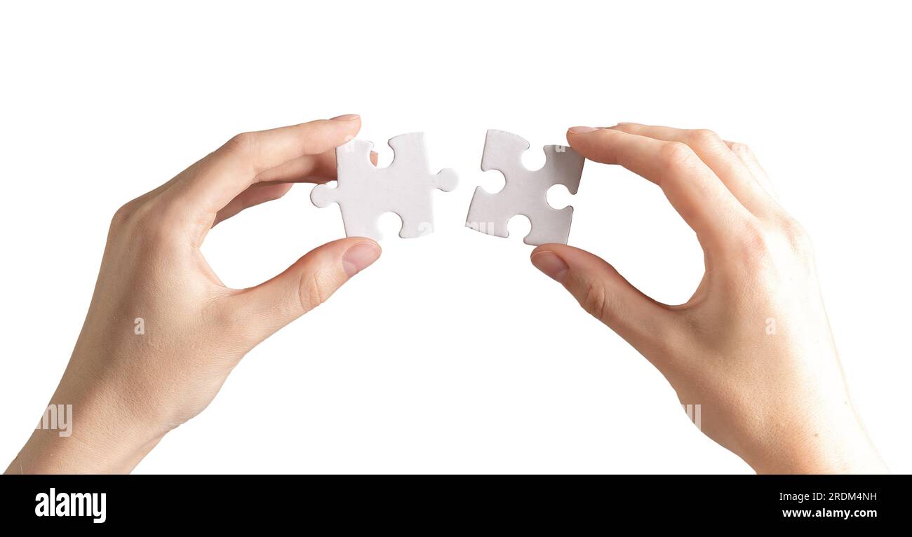 Hand joining, connecting two puzzle pieces together. Business and ...