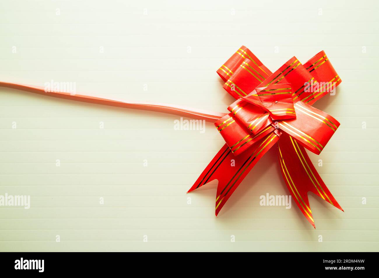 Red ribbon bow on paper background - Vintage filter effect processing ...