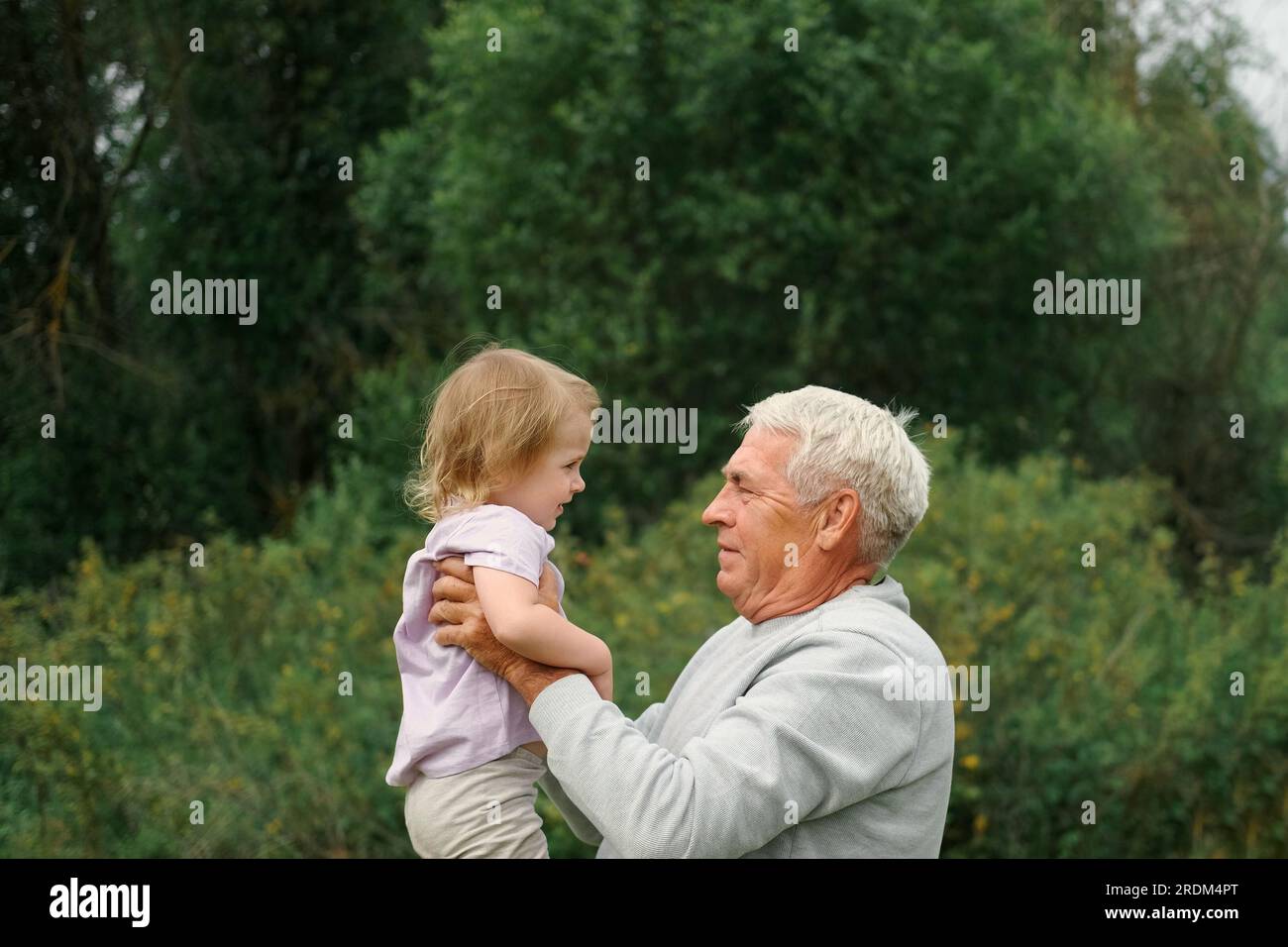 Grandfather and grandchild baby have fun during walk In Park. Happy ...