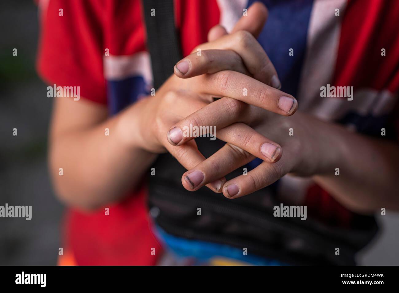 Close-up photo of the boy's hands. The hands of a yard boy. Long ...