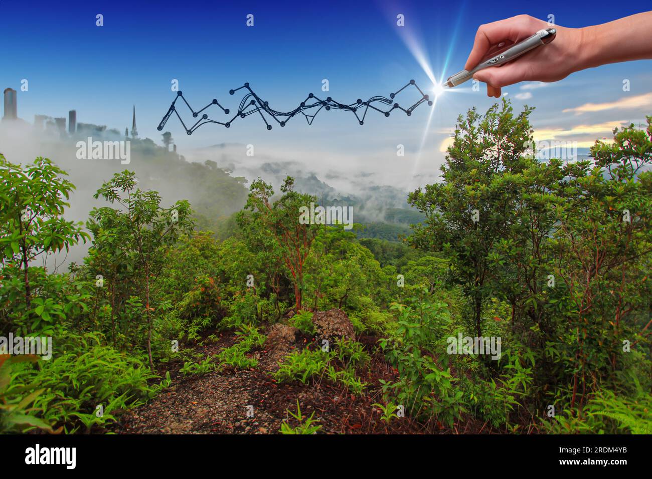 Hand drawing a growing graph on a mountain with cityscape in the ...