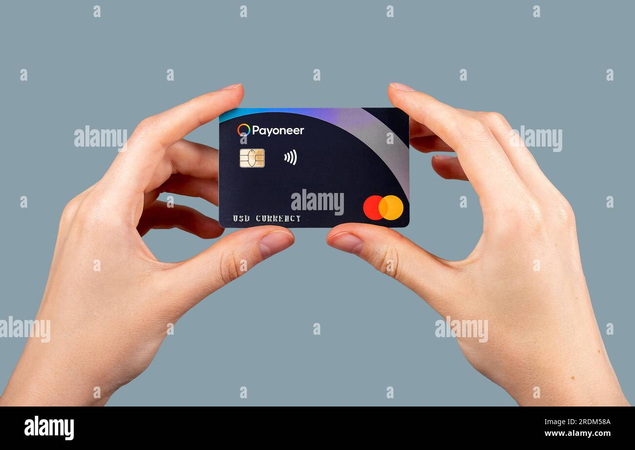 Payoneer, plastic bank card in hands Stock Photo - Alamy