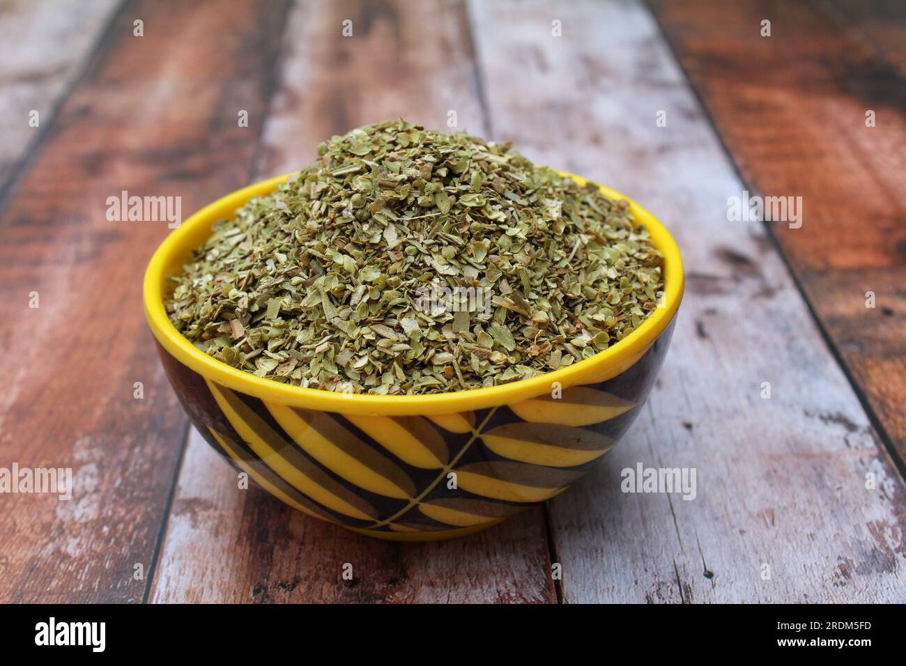 Dried oregano spice in a bowl close-up view Stock Photo - Alamy