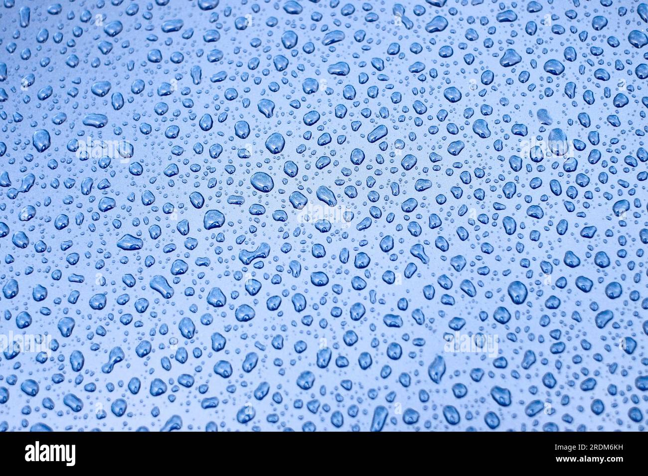 Blue reflective surface with water drops Stock Photo - Alamy