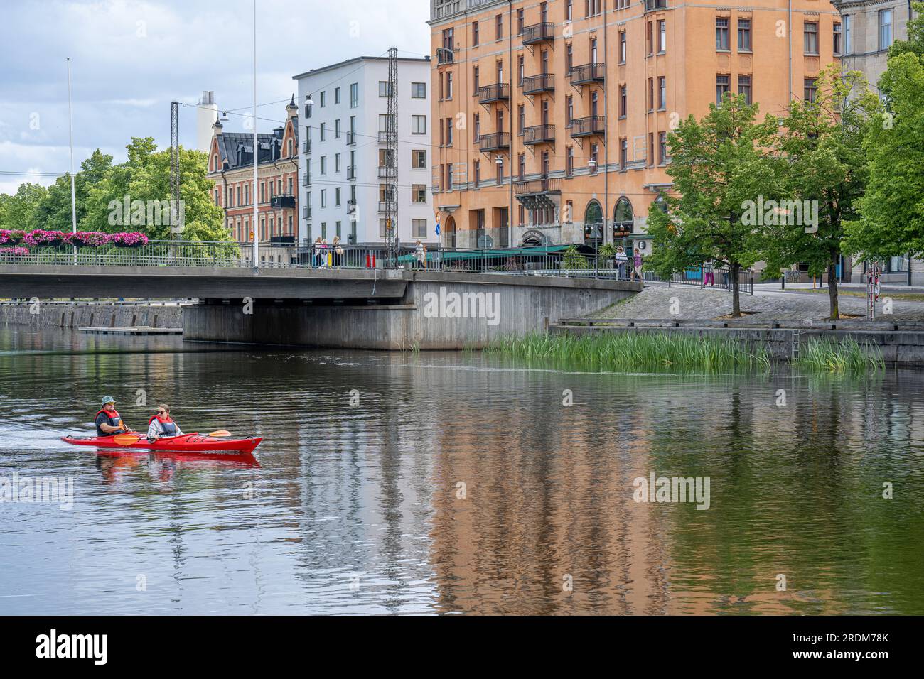 People kayaking in Motala river with Grand Hotel at Norrköping ...
