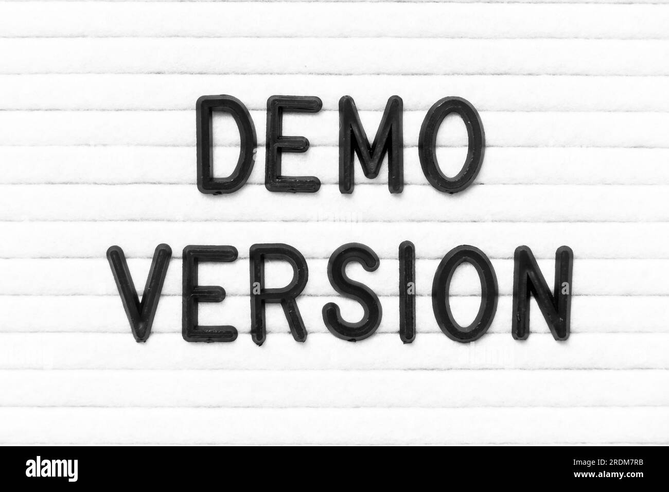Black color letter in word demo version on white felt board background ...