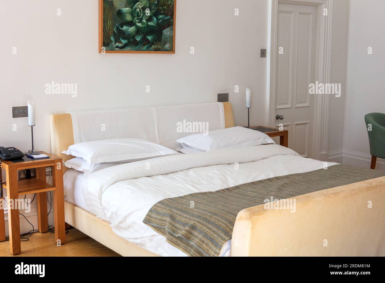 Bedroom interior with large simply made up bed Stock Photo - Alamy