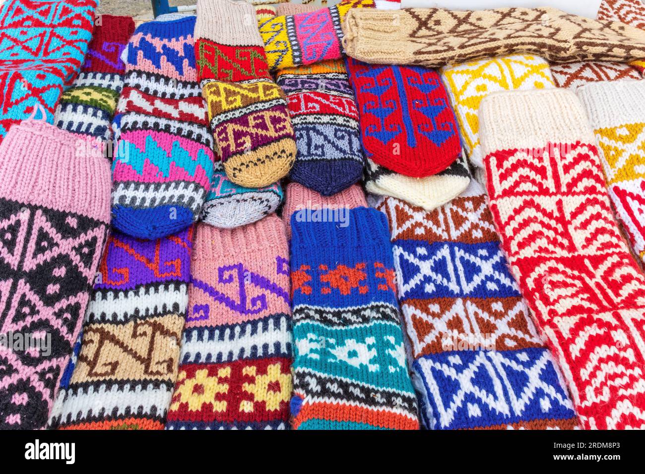 Rows of hand knitted woolen socks in multicolour patterns displayed at ...