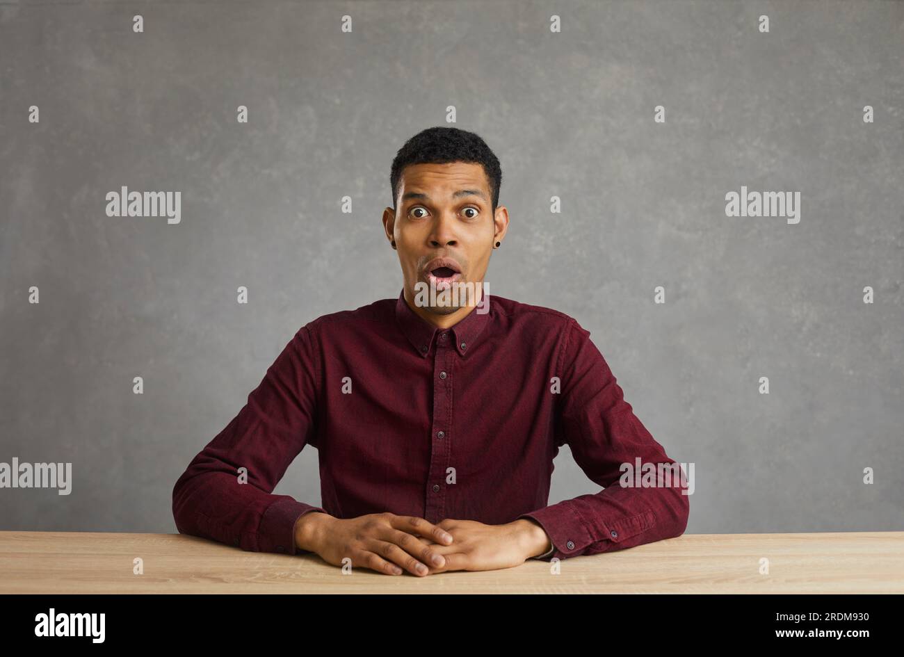 Dark skinned man with a surprised and shocked expression stunned by ...