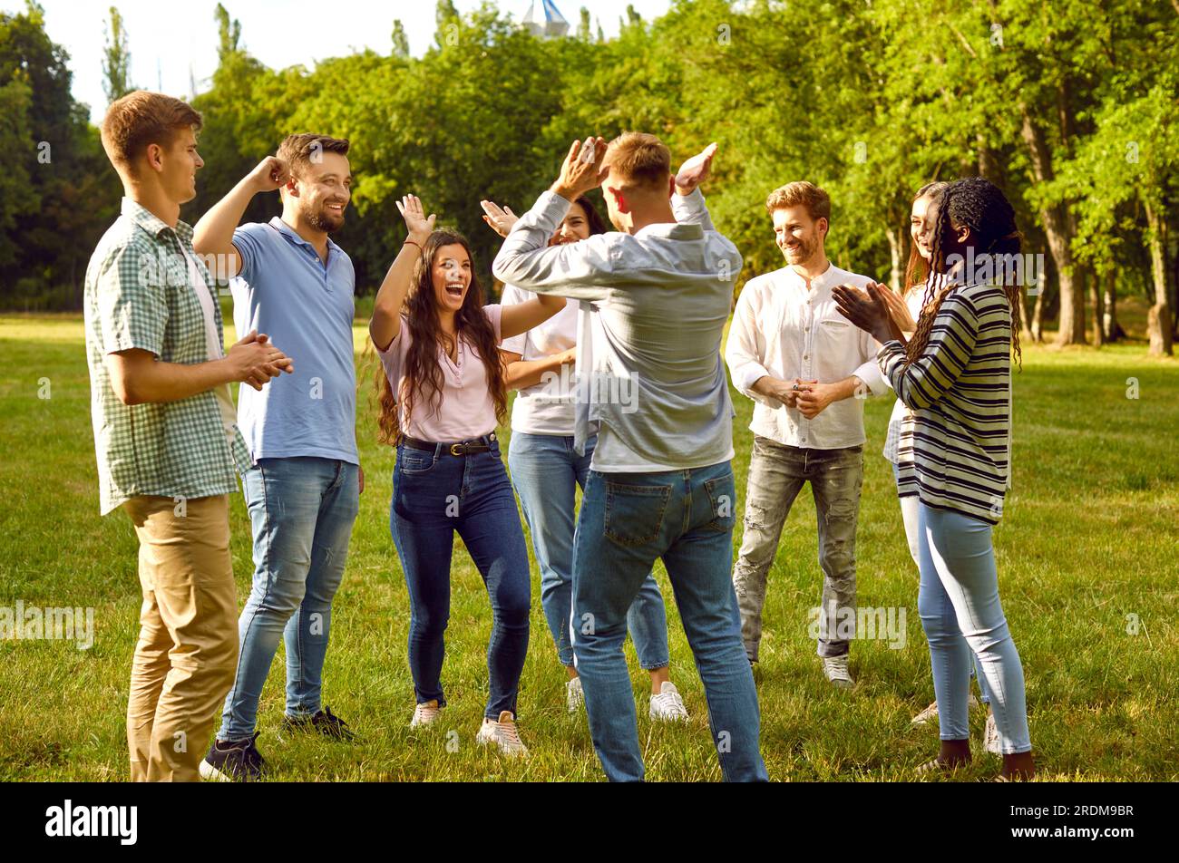 Large group of fun cool young best friends hanging out together in park in summer Stock Photo ...