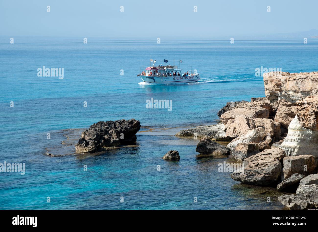 Tourist yacht sailing in the sea with tourists enjoying summer holidays ...