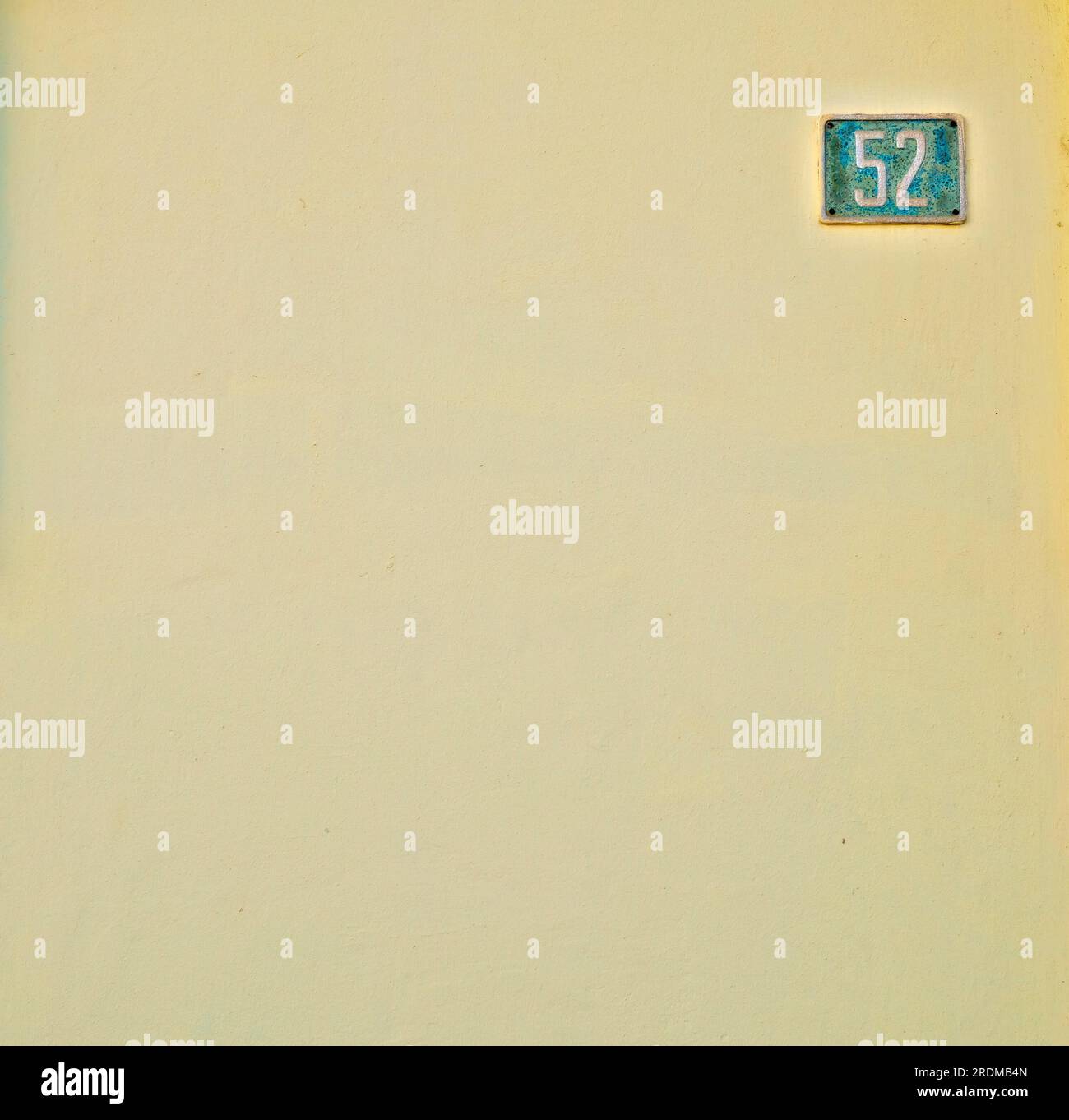 Number 52, fifty-two, blue offset plate on square pale yellow ...