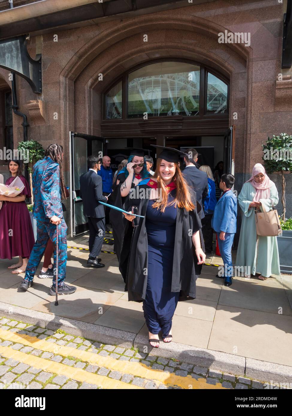 The image is of groups of graduates with family and friends celebrating ...