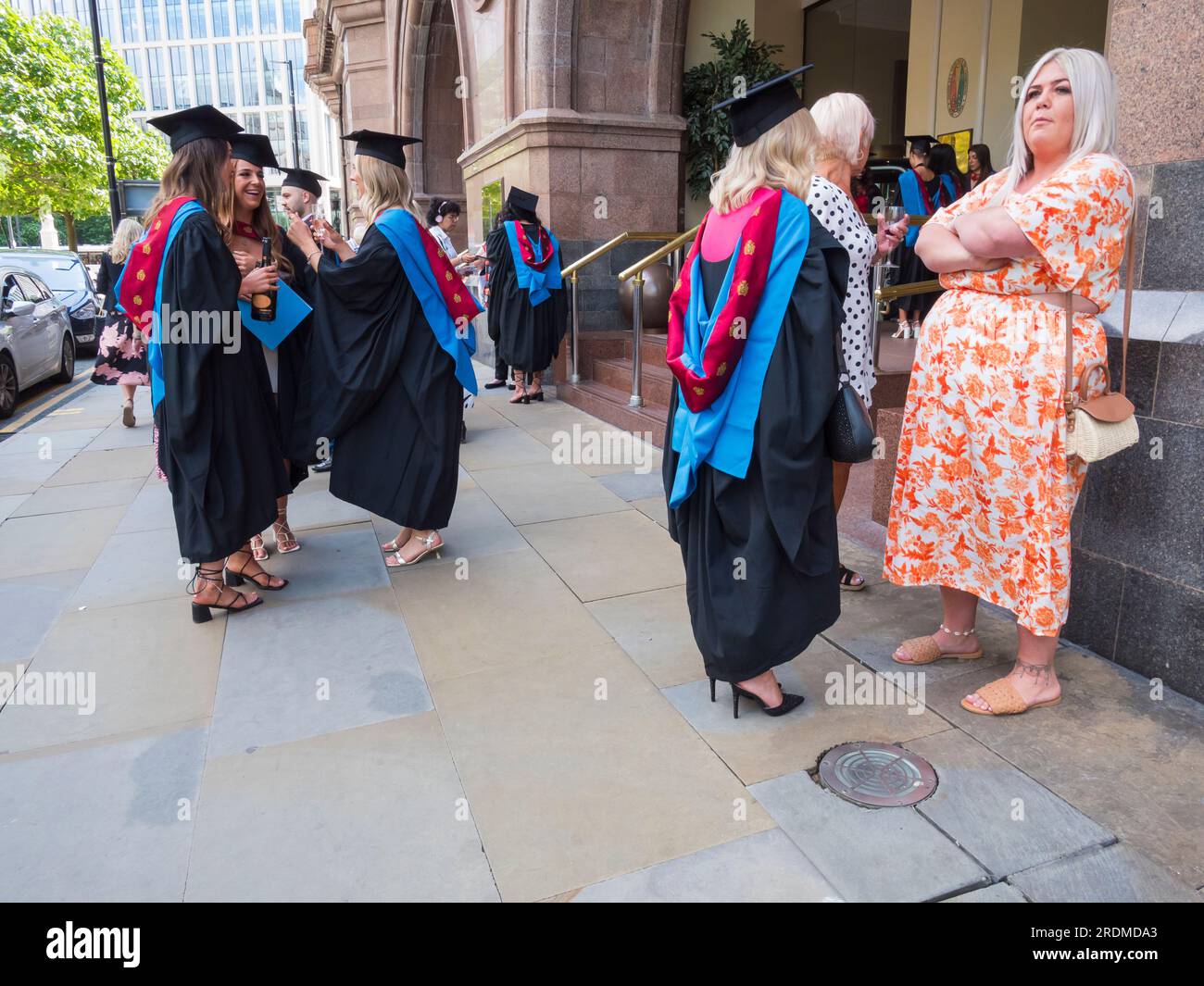 The image is of groups of graduates with family and friends celebrating ...