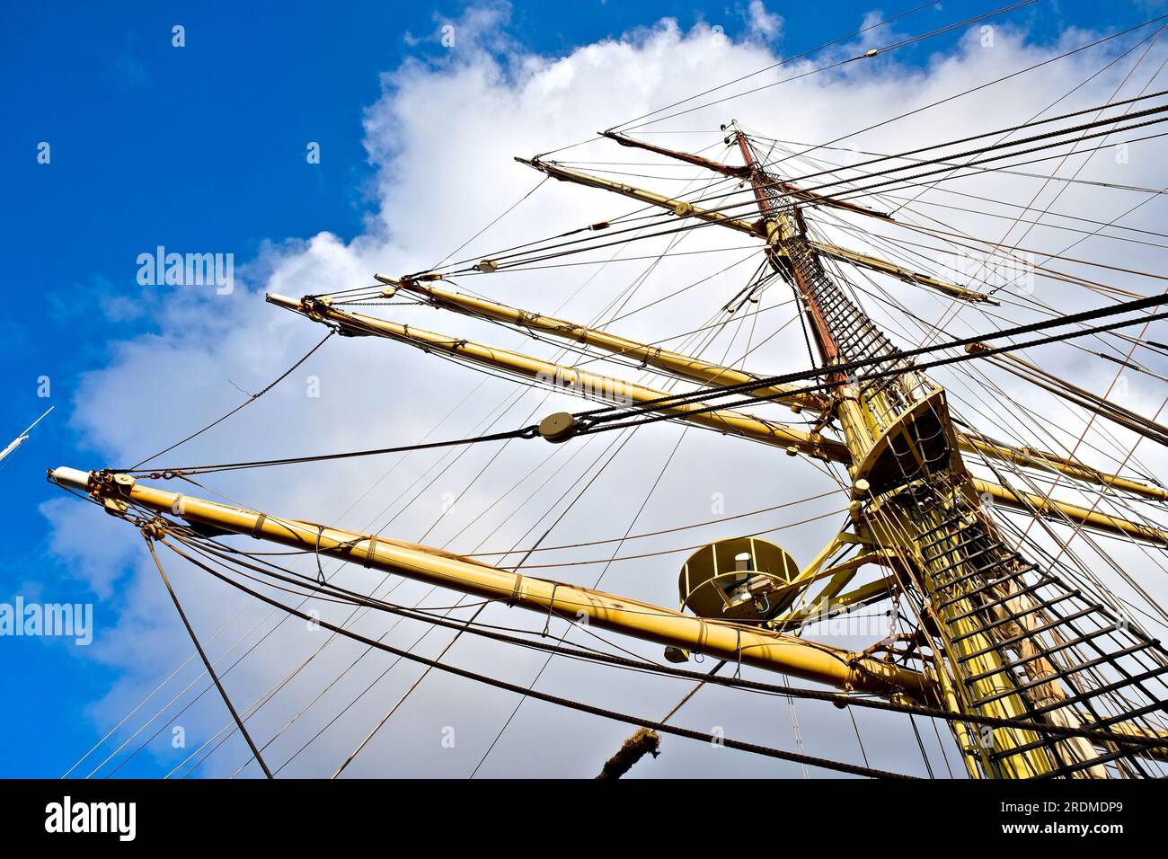 Tall ship yards and masts and its standing and running rigging, sky and ...