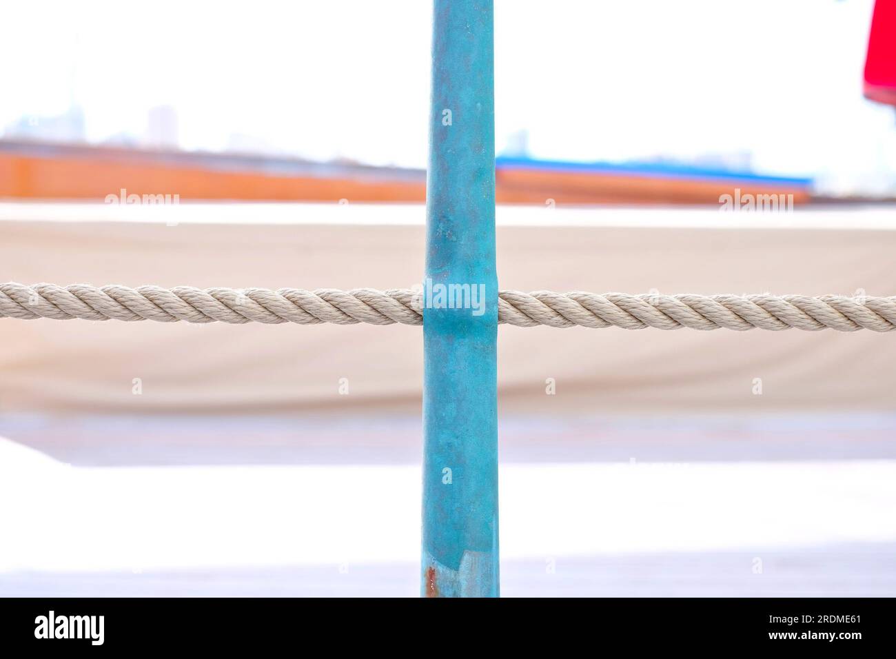 A detail view of a bronze stanchion and a hempen lifeline, details of ...