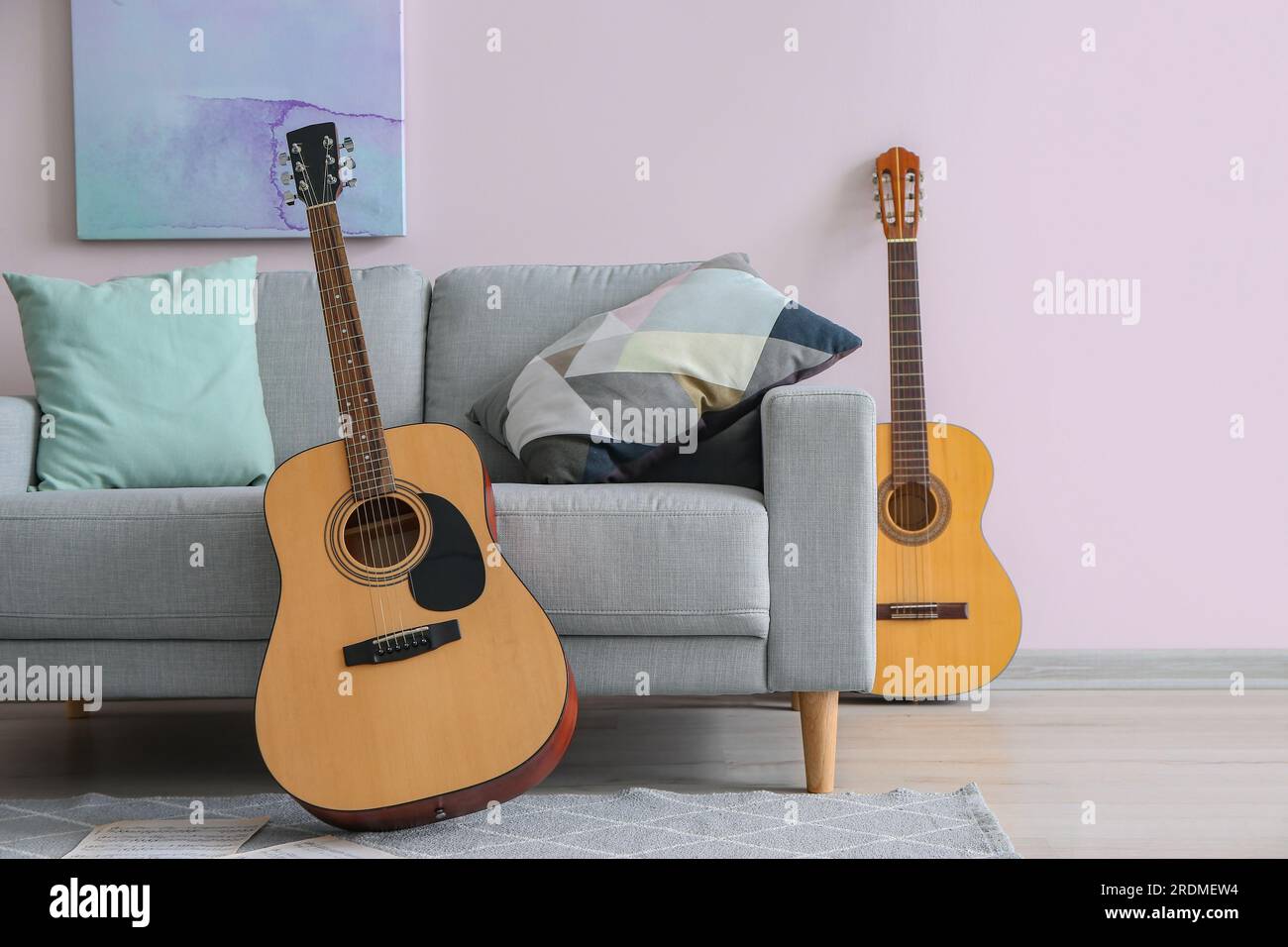 Interior of room with sofa and guitars Stock Photo - Alamy