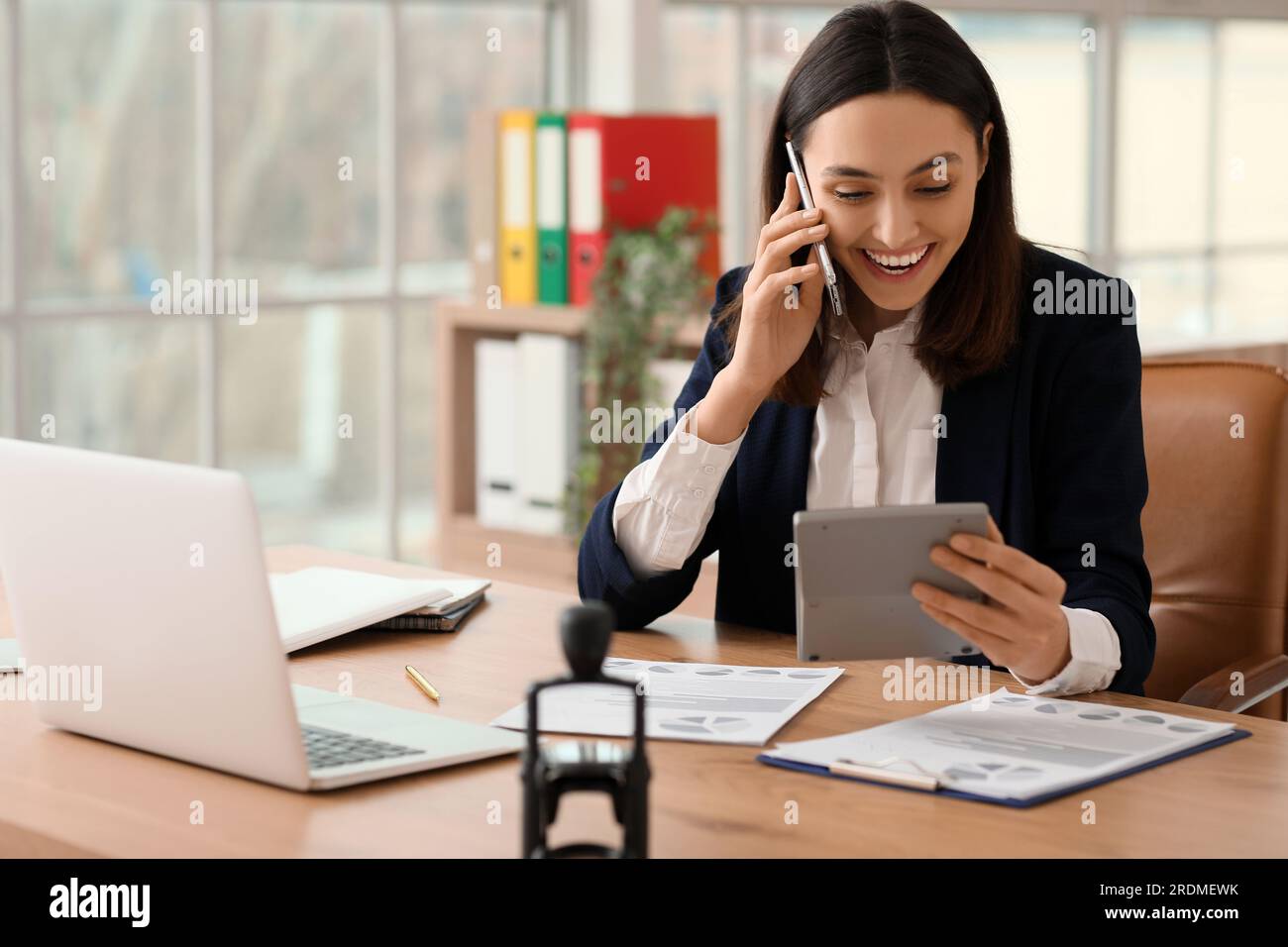 Female accountant working with calculator at table in office Stock ...