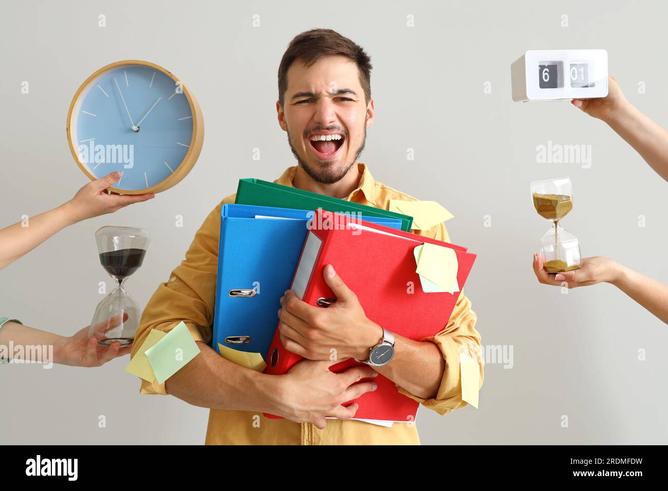 Stressed young man and hands with clocks on light background. Deadline concept Stock Photo - Alamy