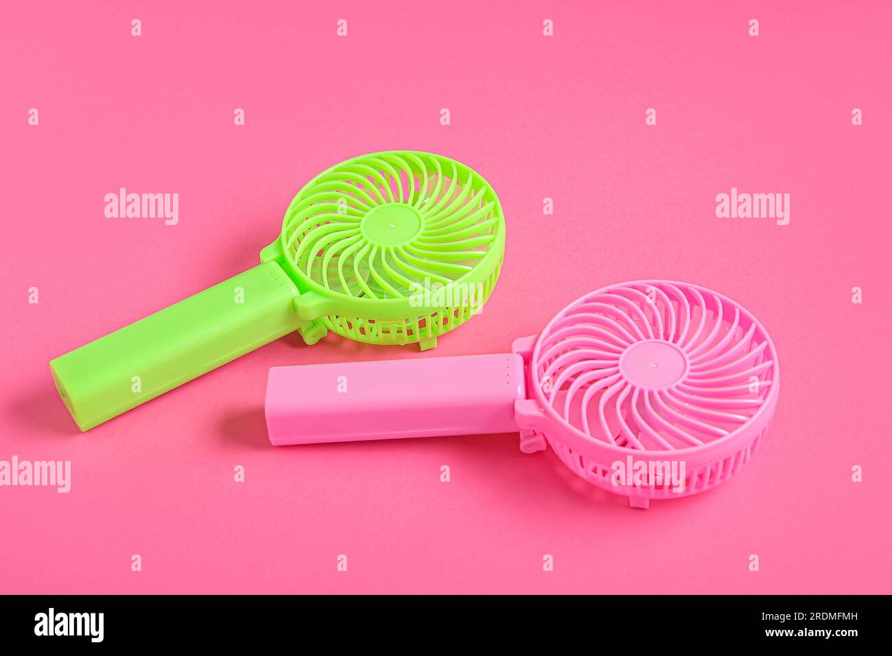 Different manual fans on pink background, closeup Stock Photo - Alamy