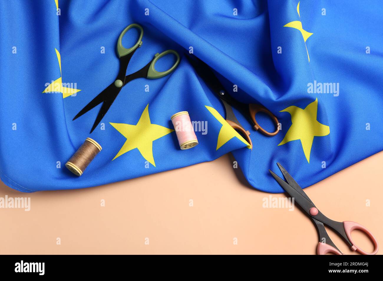 Scissors, threads and flag of European Union on beige background Stock ...