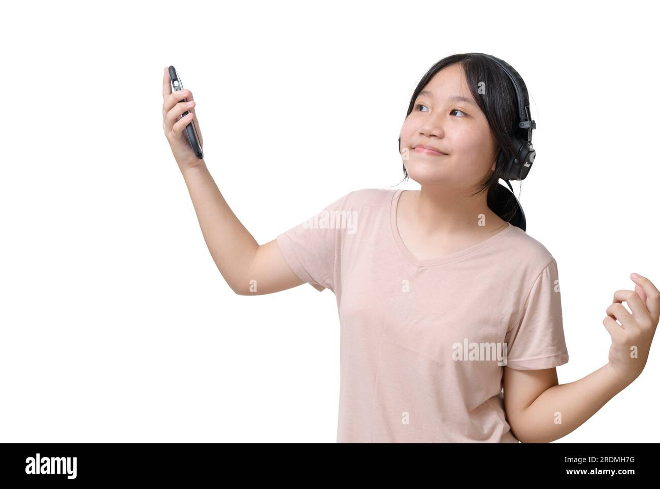 Charming asian girl wear headphones holding mobile phone listen music ...