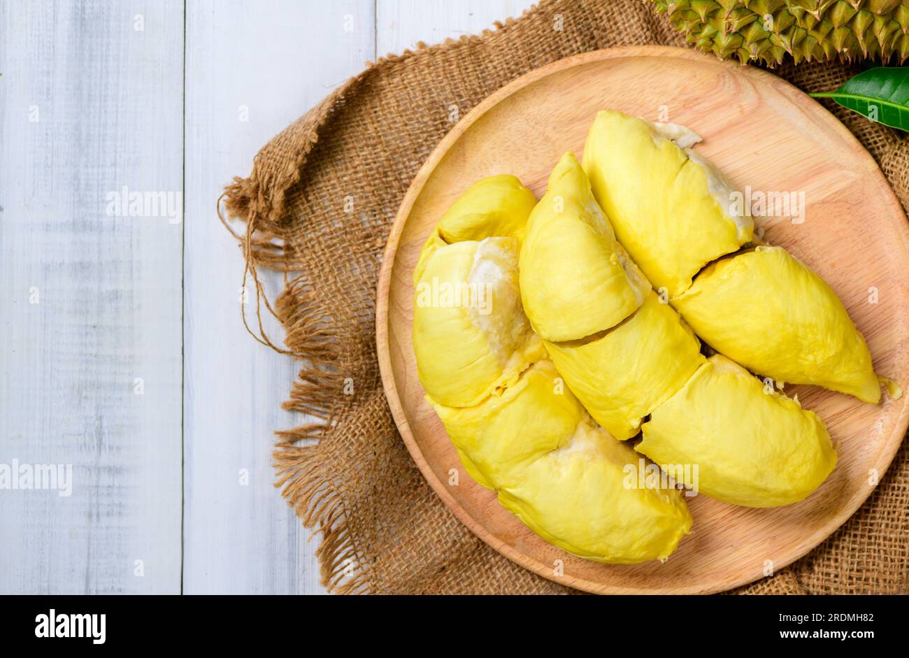 Top view of Durian fruit. Ripe monthong durian on wood plate and white wood background, king of ...