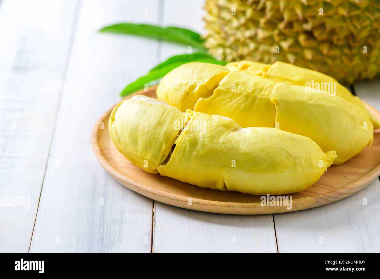 Durian fruit. Ripe monthong durian on wood plate and white wood background, king of fruit from ...