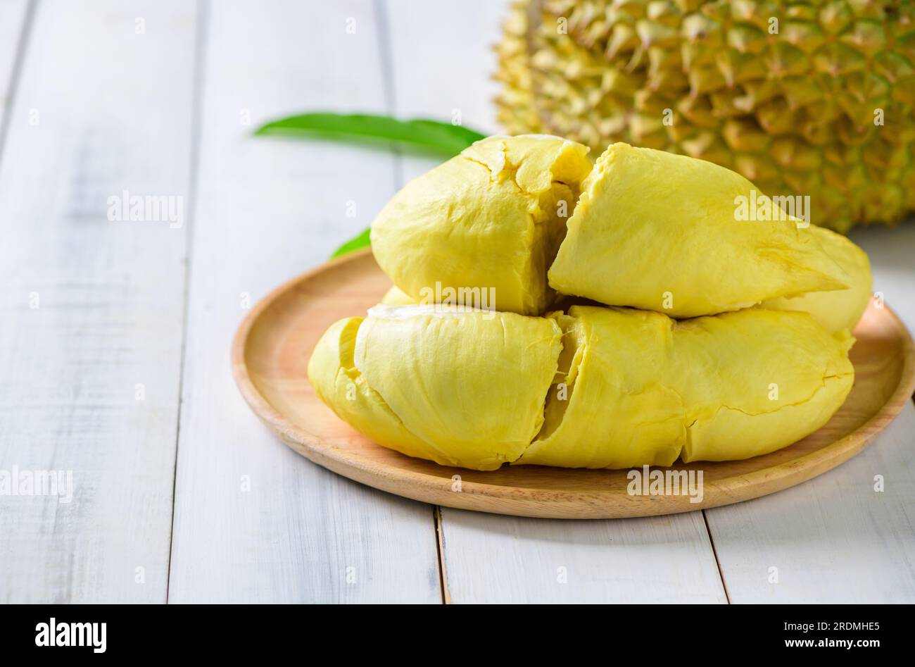 Durian fruit. Ripe monthong durian on wood plate and white wood background, king of fruit from ...