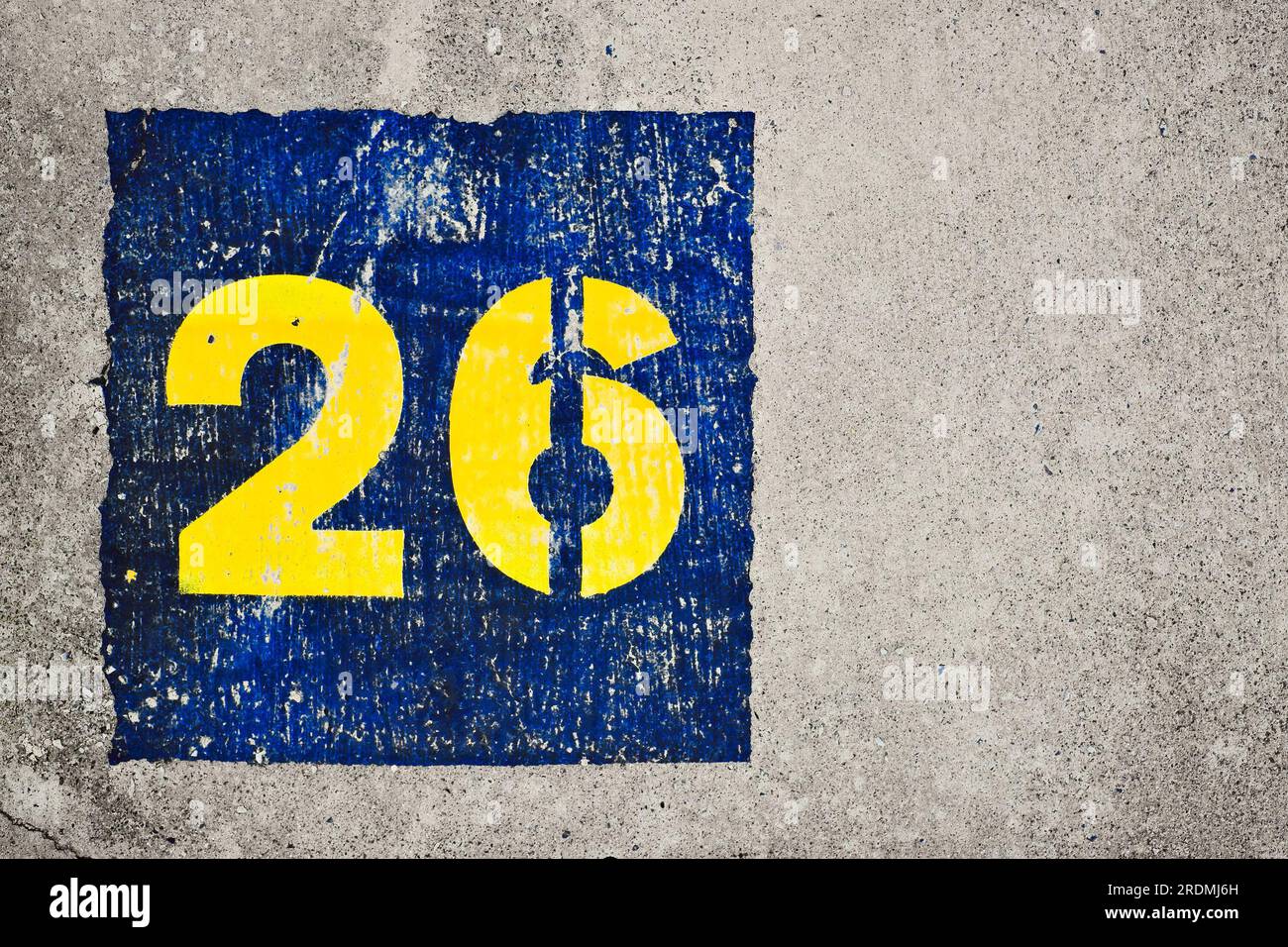 Number 26, twenty-six, blue and yellow on concrete surface Stock Photo ...
