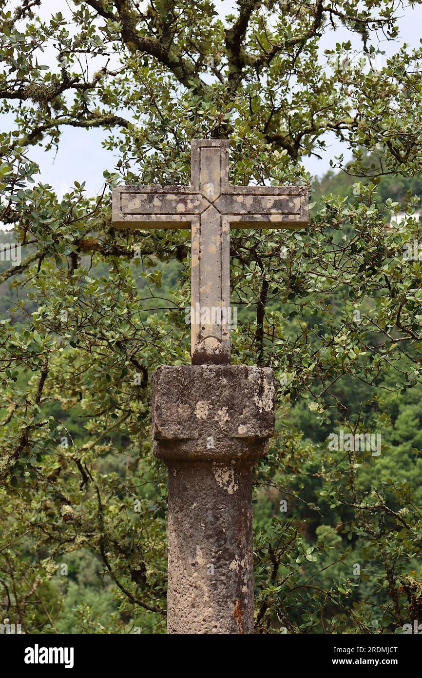 Christian stone cross amidst trees and vegetation. Sanctuary of Nossa ...
